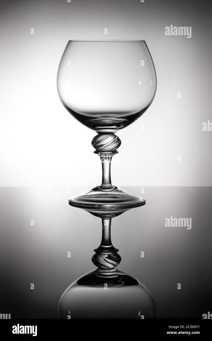Brandy glass in backlight and reflection in black and white Stock Photo ...