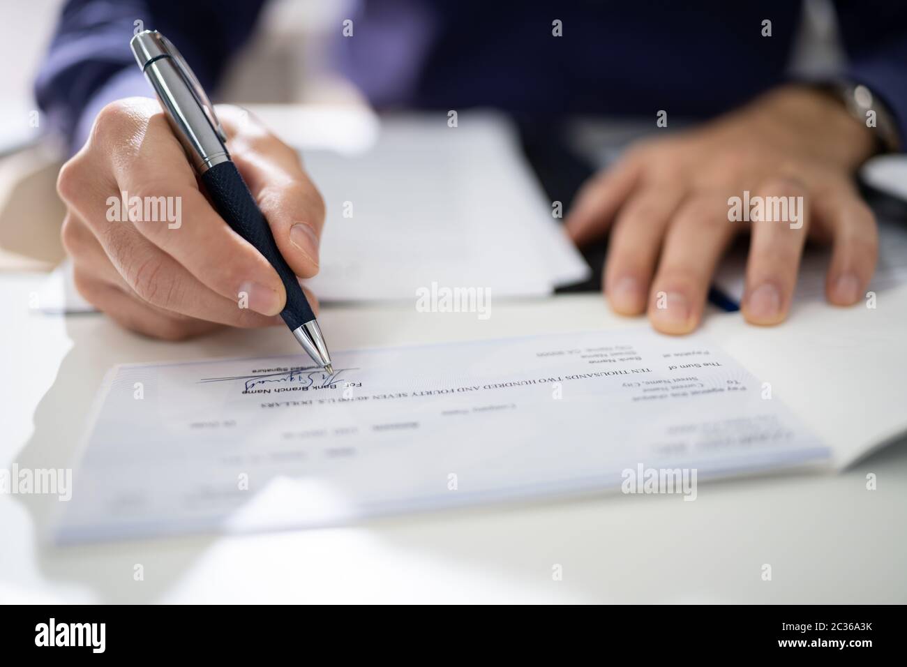 Close-up Of Human Hand Writing On Cheque Stock Photo - Alamy
