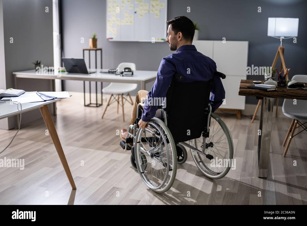 Man sitting desk in wheelchair hi-res stock photography and images - Alamy