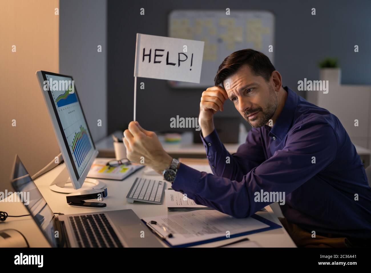Businessman Holding Help Flag Over The Desk At Workplace Stock Photo ...