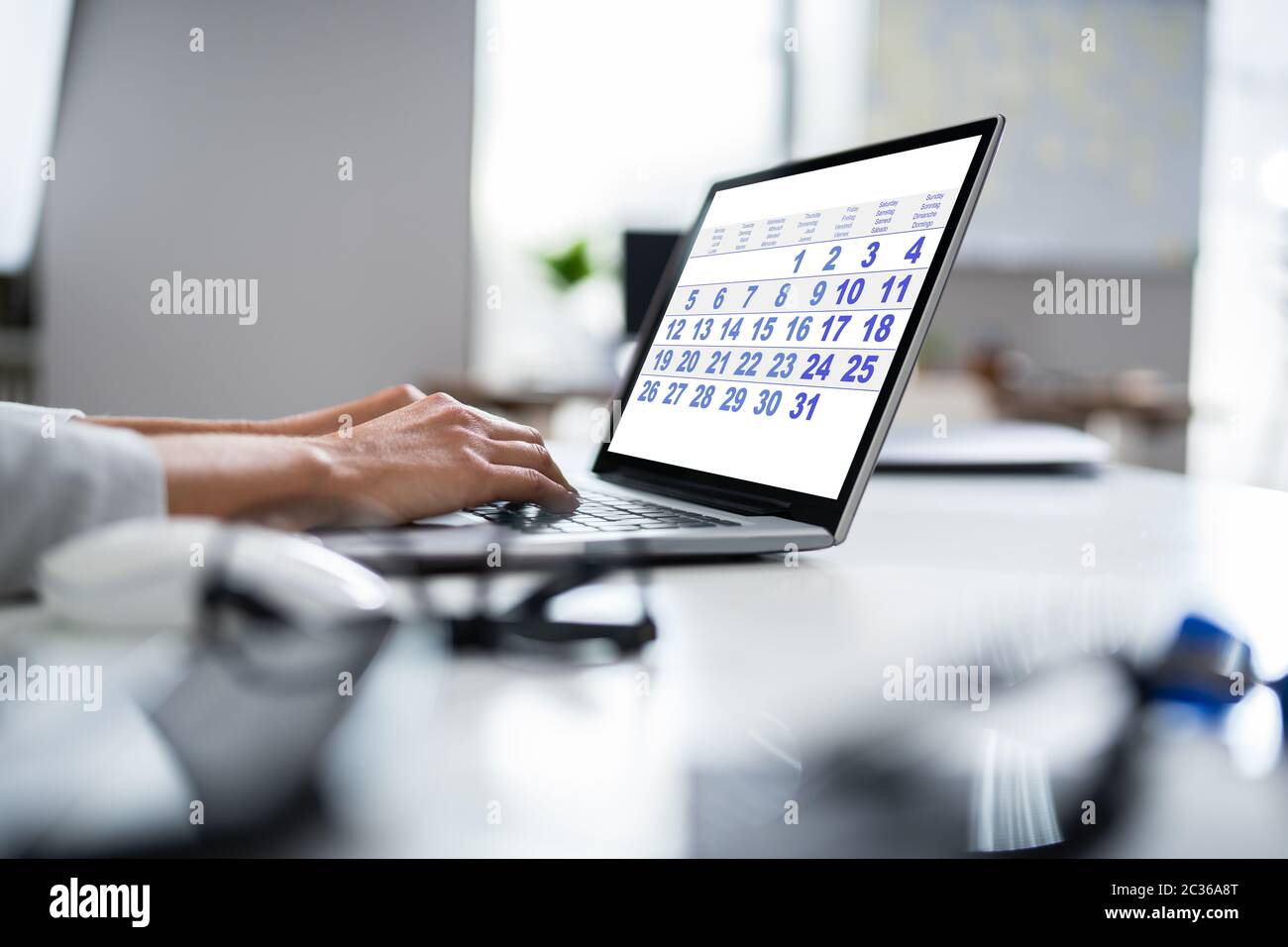 Woman looking at calendar on desk hi-res stock photography and images ...