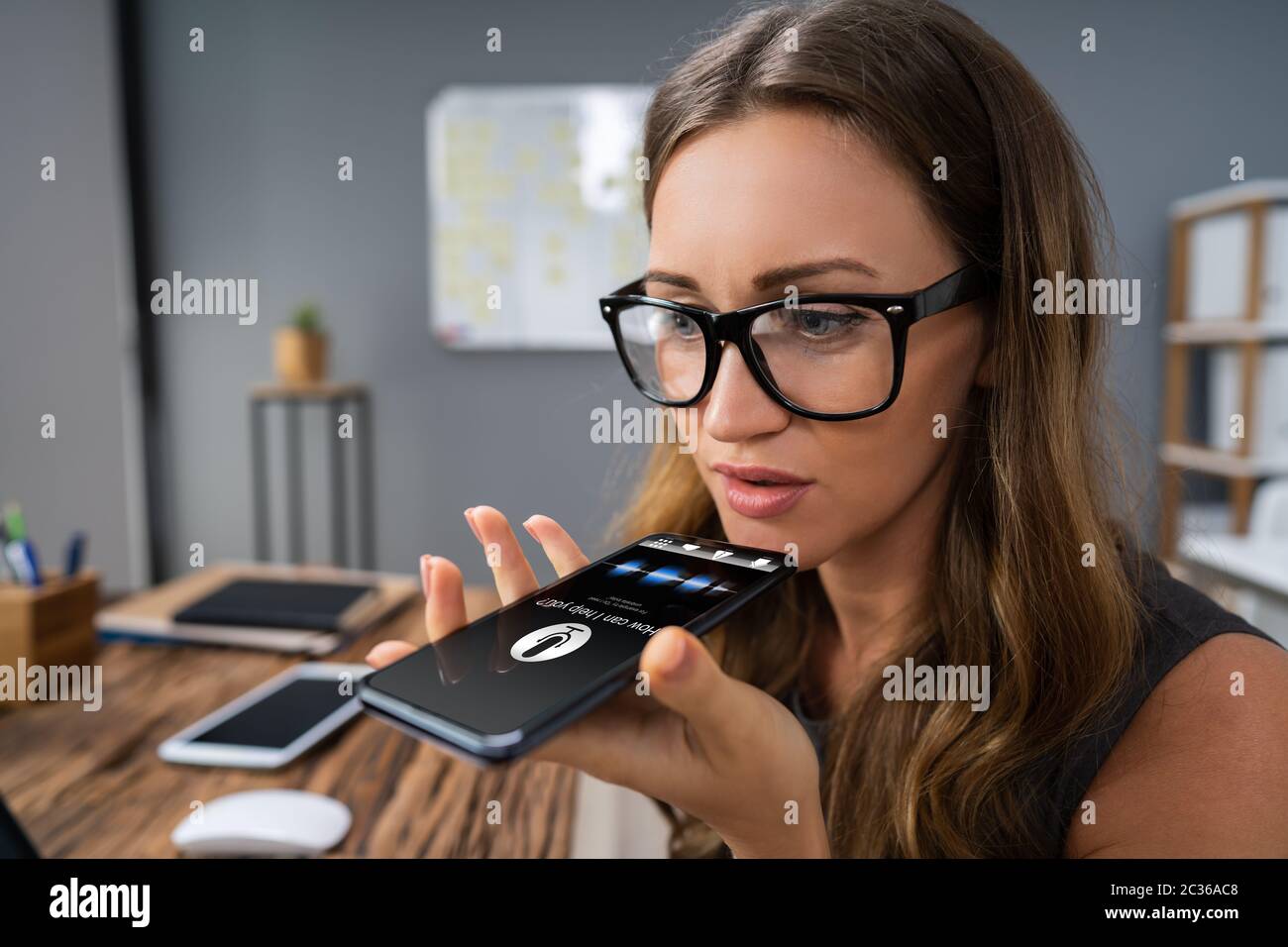 Close-up Of An Woman Using Voice Assistant On Cellphone Stock Photo - Alamy