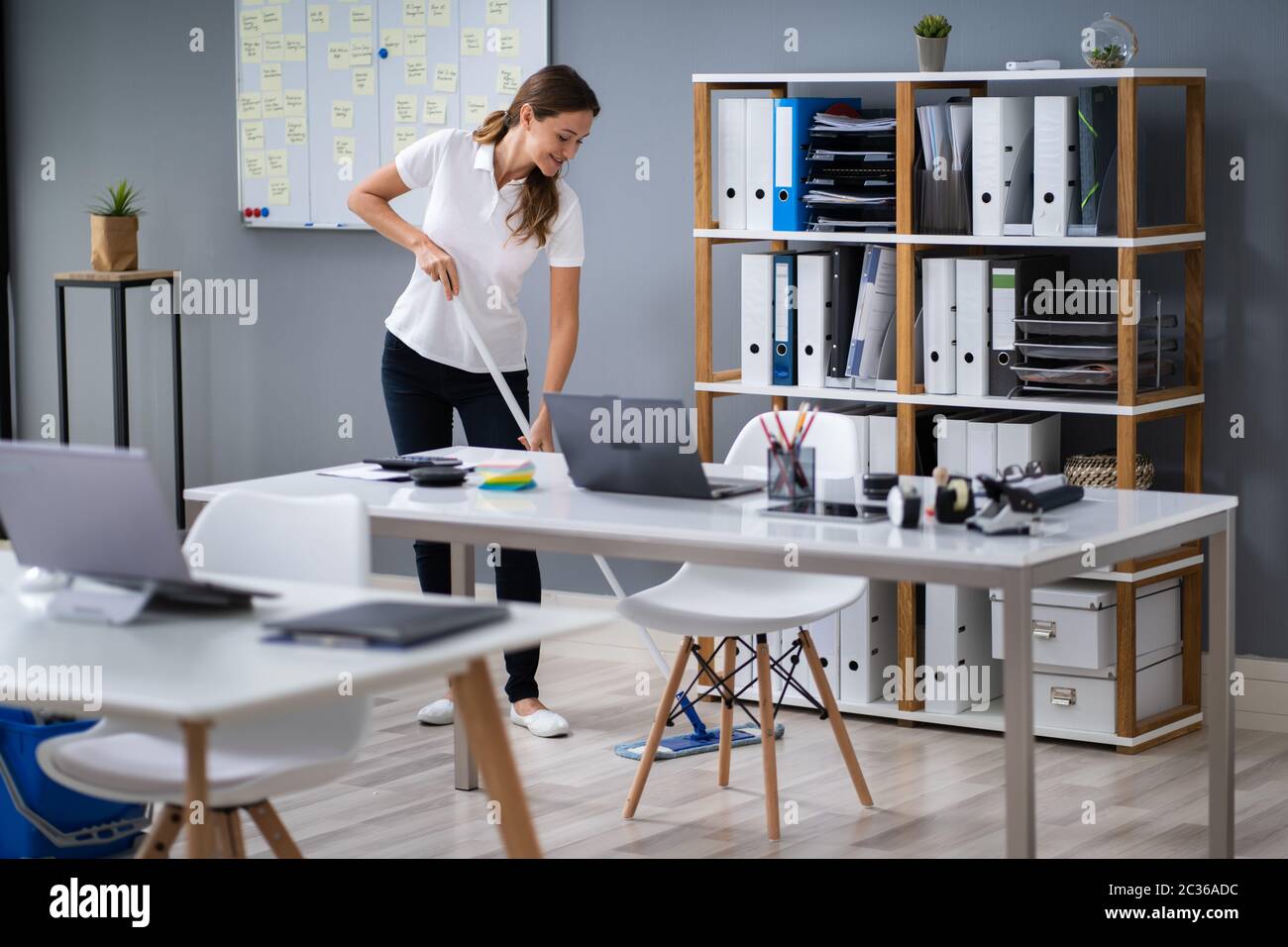 Female janitor caution sign hi-res stock photography and images - Alamy