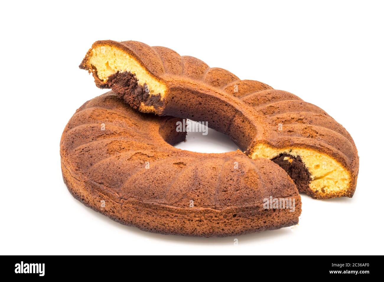 Circular marbled cake cut in half on a white background Stock Photo - Alamy