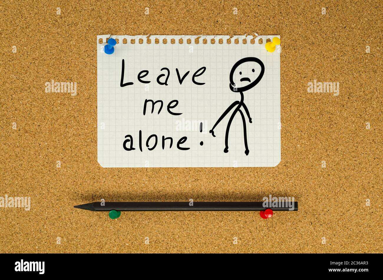 Leave me alone text note message pin on bulletin board Stock Photo - Alamy