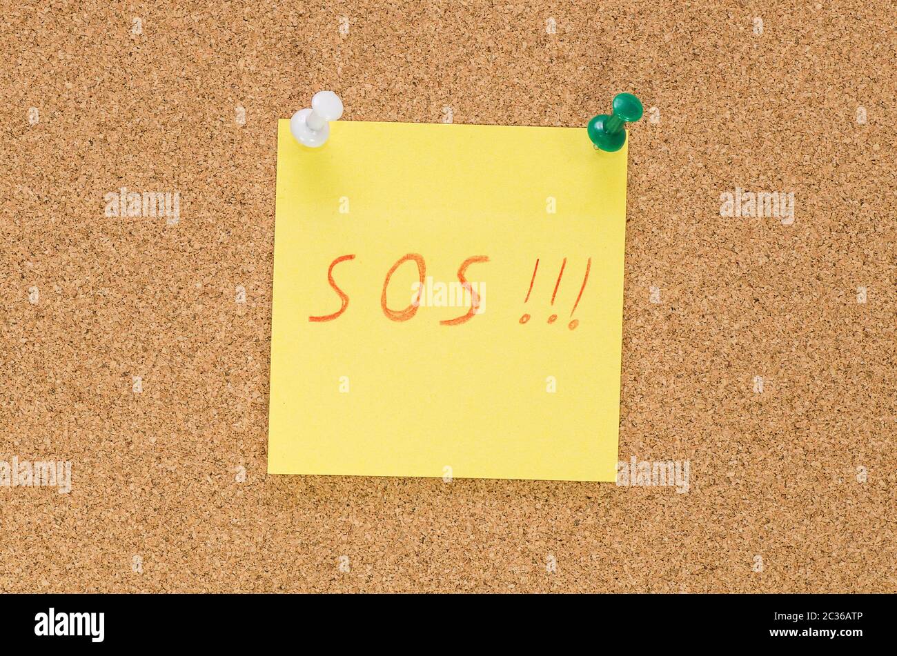 Sos note pinned on the bulletin board Stock Photo - Alamy