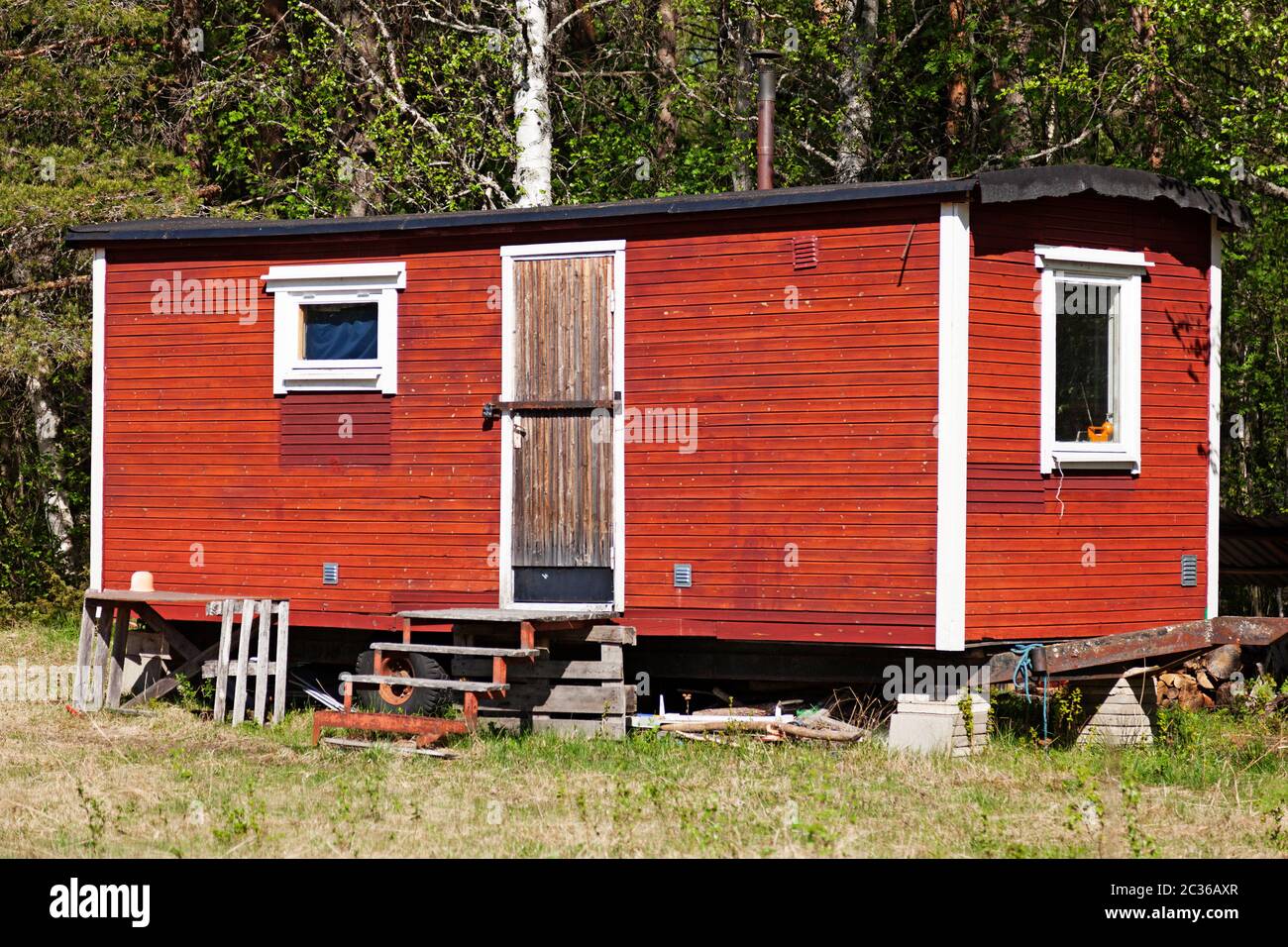 a simple and mobile summer house in red wood Stock Photo - Alamy