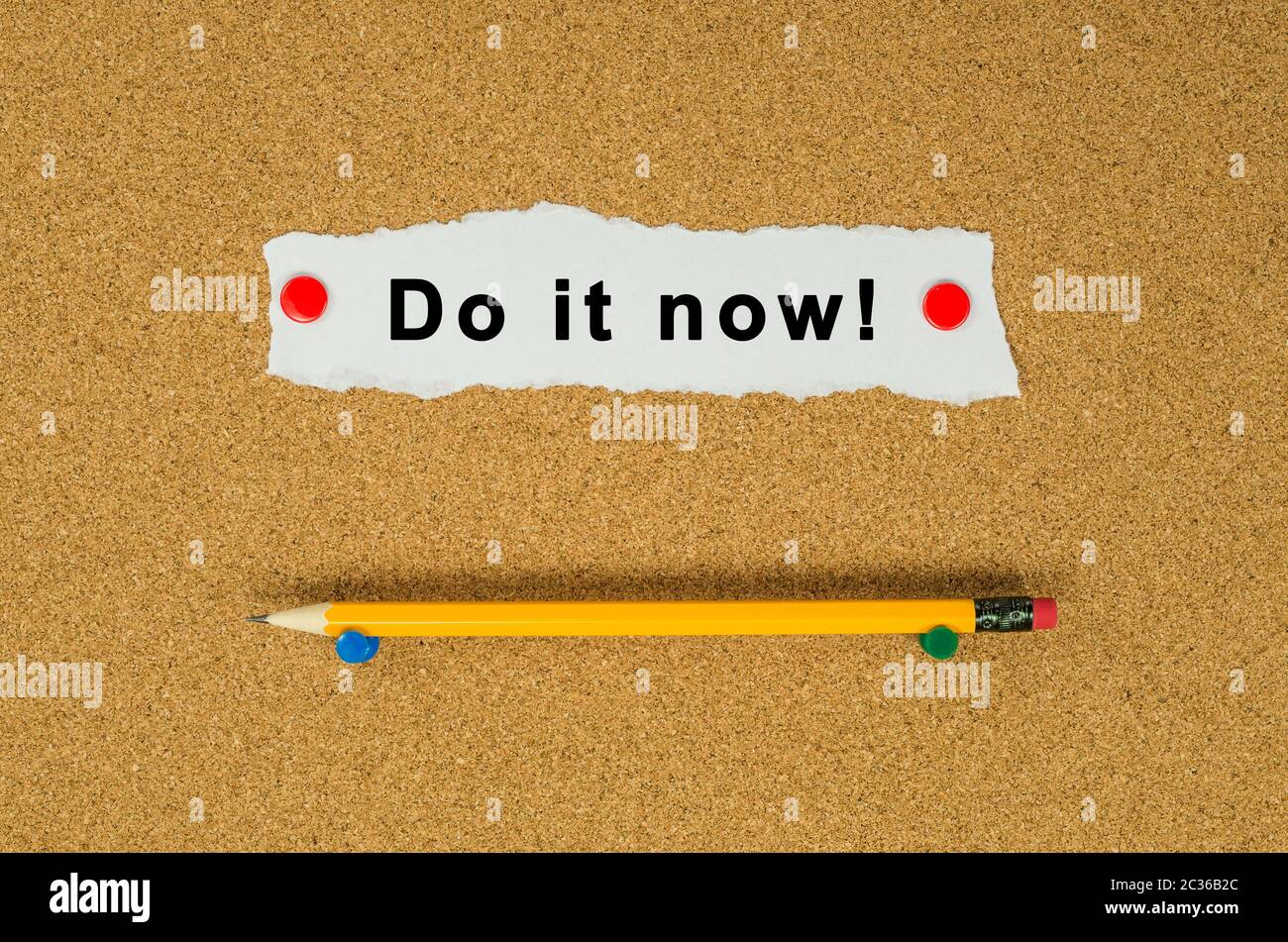 Do it now text note message pin on bulletin board Stock Photo - Alamy