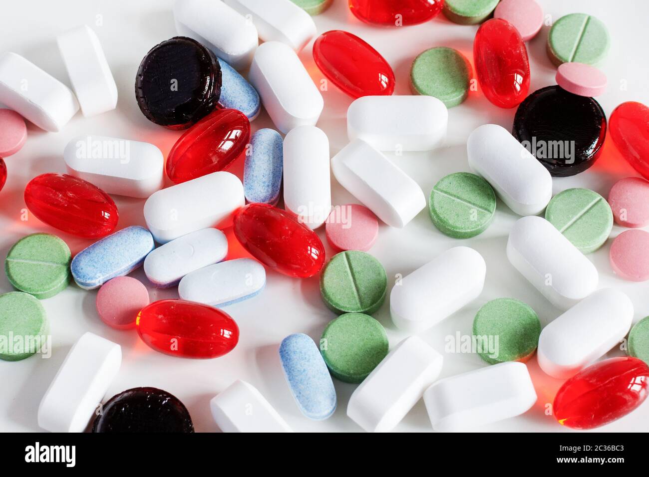 Pile of colorful medicine pills over white background. Pharmaceuticals ...