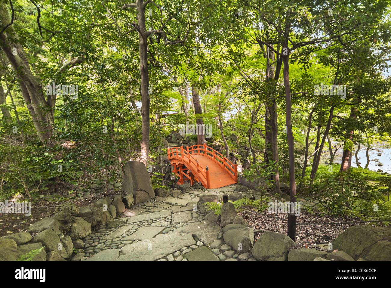 Staircase paved leading to a japanese vermilion bridge surrounded by ...