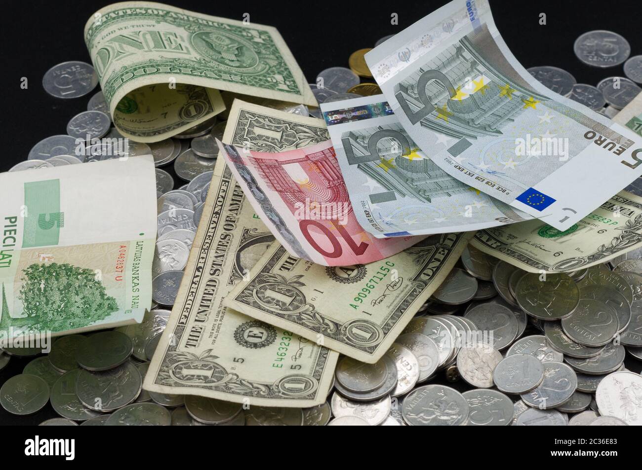 Several different banknotes on the coins background Stock Photo - Alamy