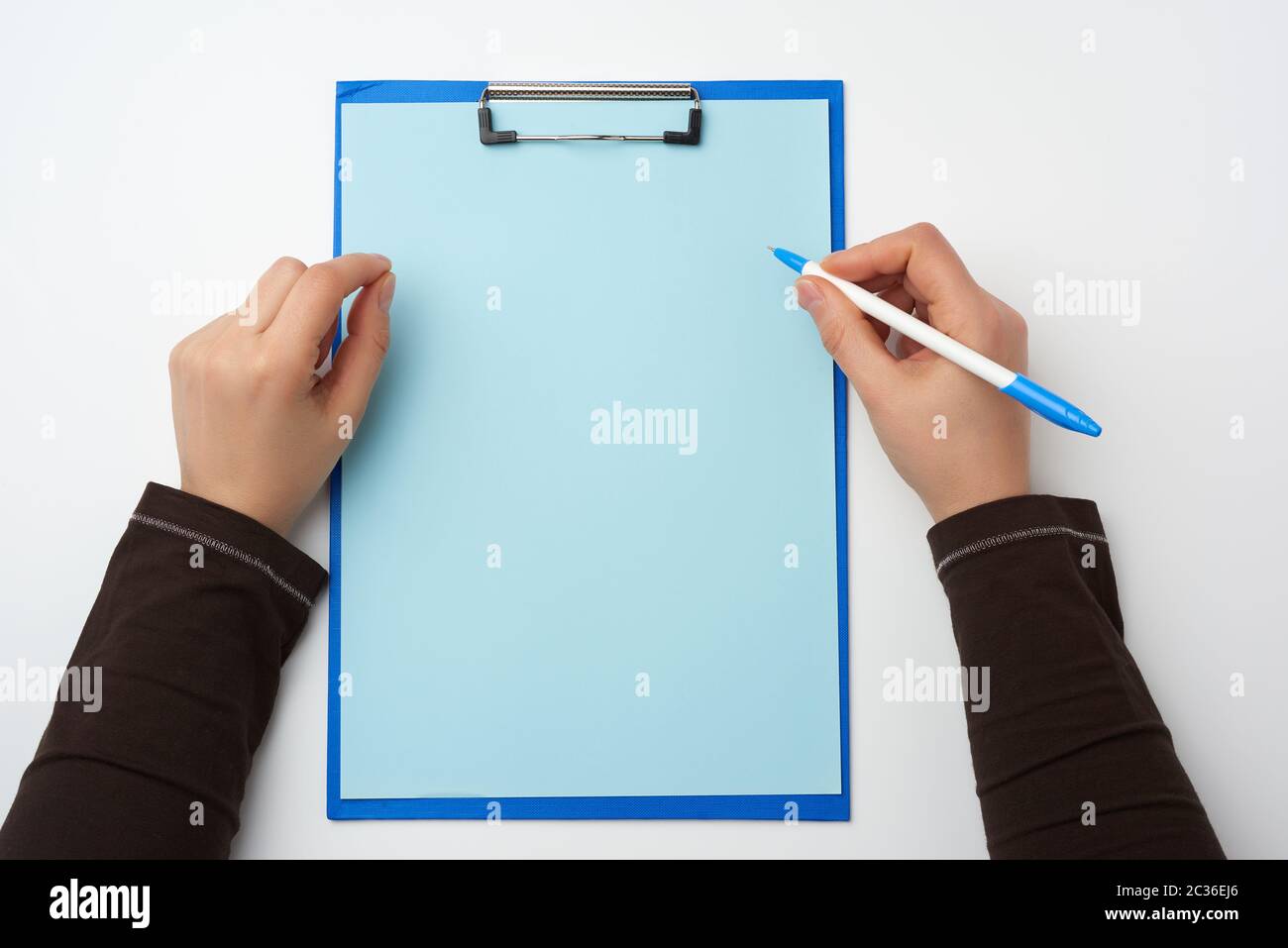 paper holder and two hands on a white background, place for an ...