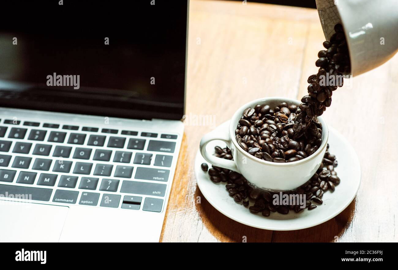Workplace business laptop computer have coffee drop into cup, in coffee ...