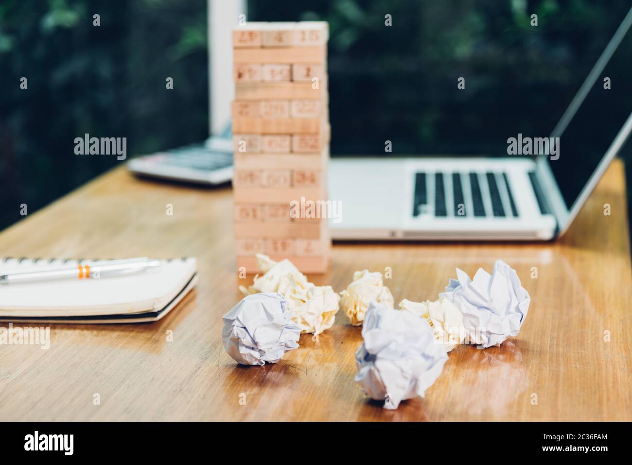 Business game wood block tower fail with paper crumpled on desk office ...