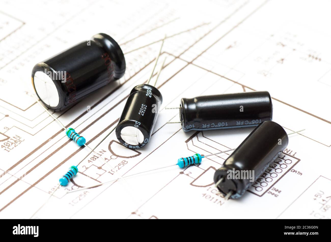 Several capacitors and resistors placed on the printed drawing Stock ...