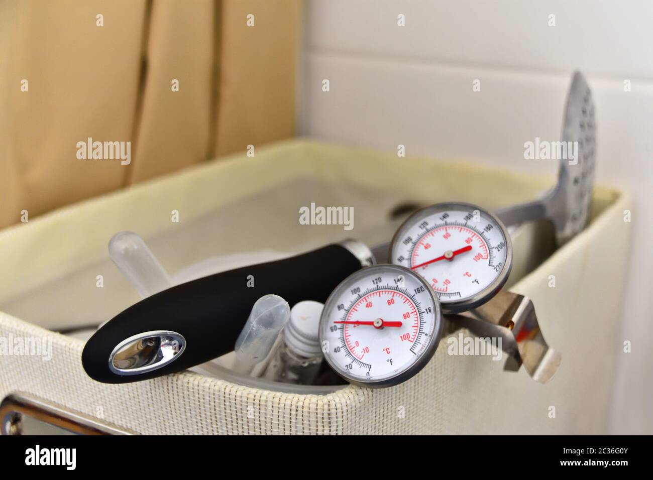 A cheese making kit with thermometers, a pipette and a strainer Stock ...