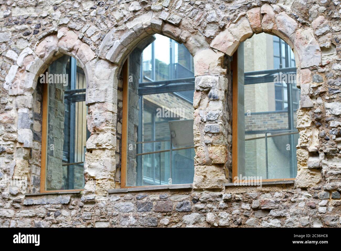 Closeup architecture detail with windows on stone house Stock Photo - Alamy