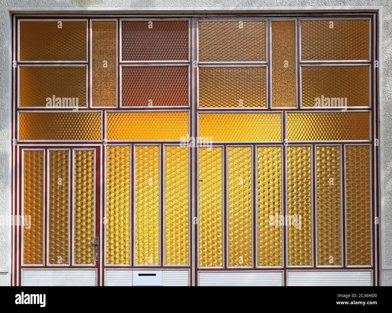 Yellow privacy glass door with decorative structure Stock Photo - Alamy