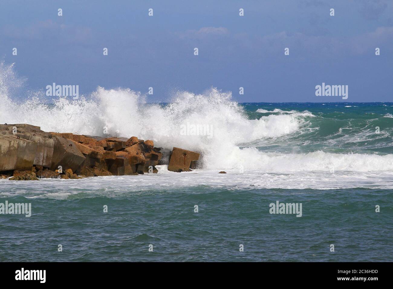 Big waves hitting concrete breakwall at Mediterranean sea Stock Photo ...