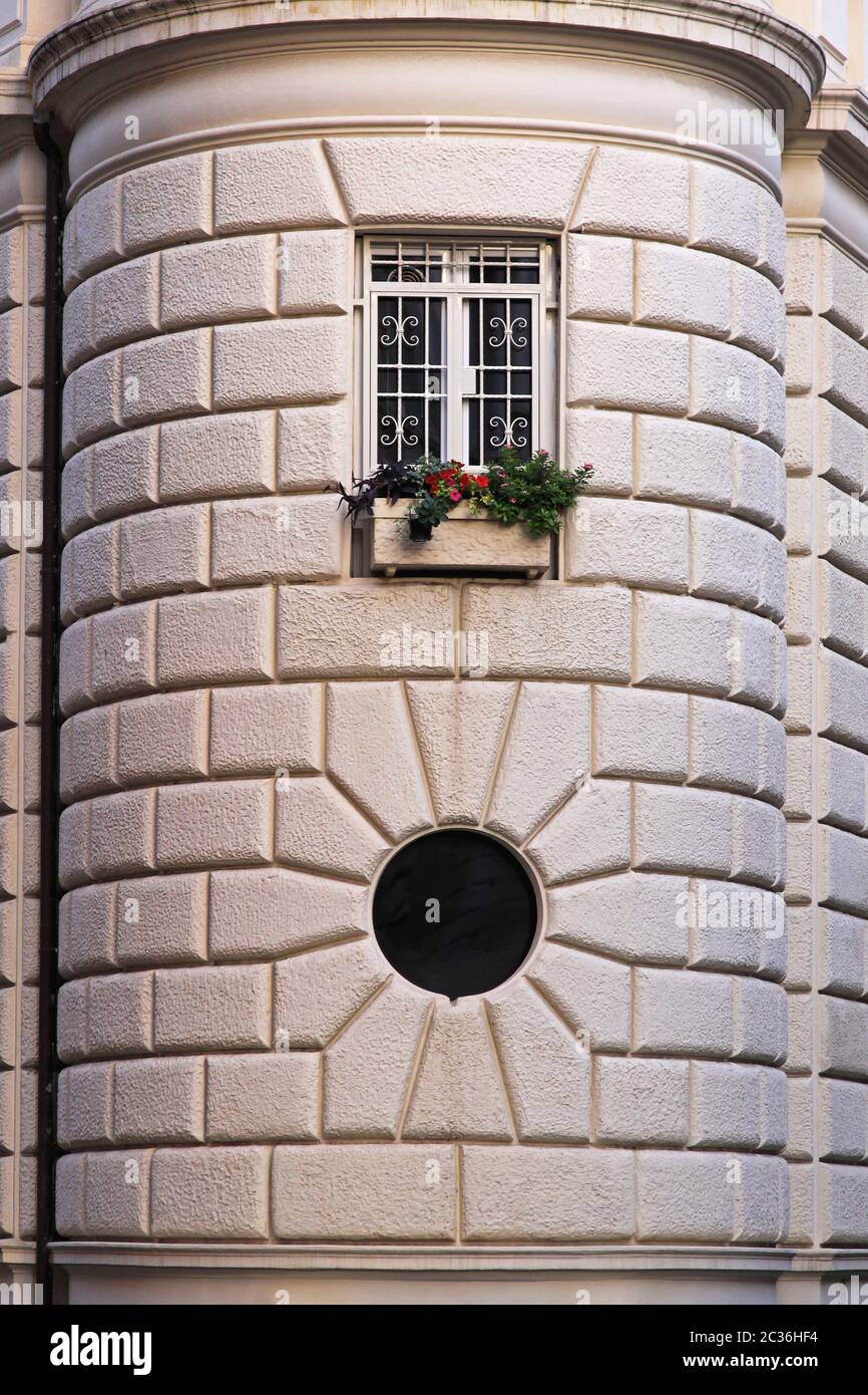 Round corner with windows at stone building Stock Photo - Alamy
