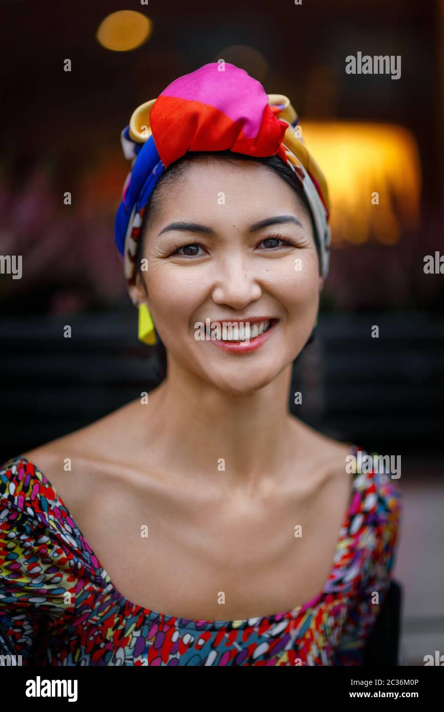 Portrait of a young woman of Asian appearance with a turban on her head ...