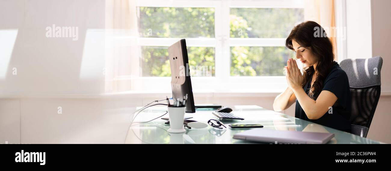 Employee Woman Praying Near Computer At Office Stock Photo - Alamy