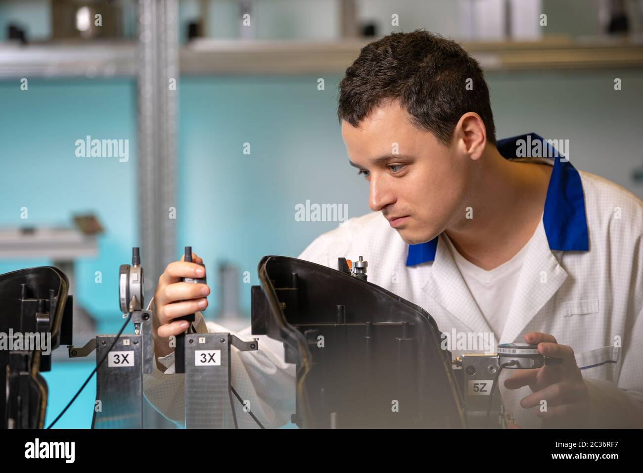 Automotive. Quality Engineer performs measurement of plastic casting ...