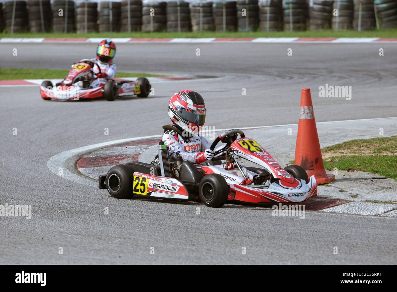 Kart racers navigating the corner on the race track Stock Photo - Alamy