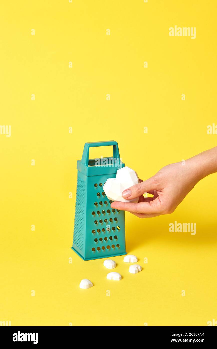 Kitchen grater and plaster heart in a woman's hand Stock Photo - Alamy