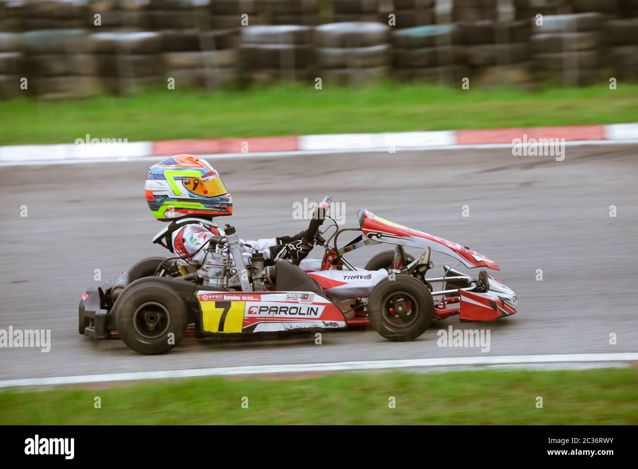 Kart racers speeding along a track corner Stock Photo - Alamy