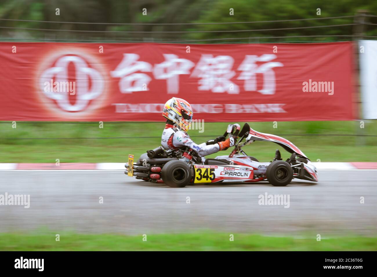 Kart racers speeding along a track corner Stock Photo - Alamy