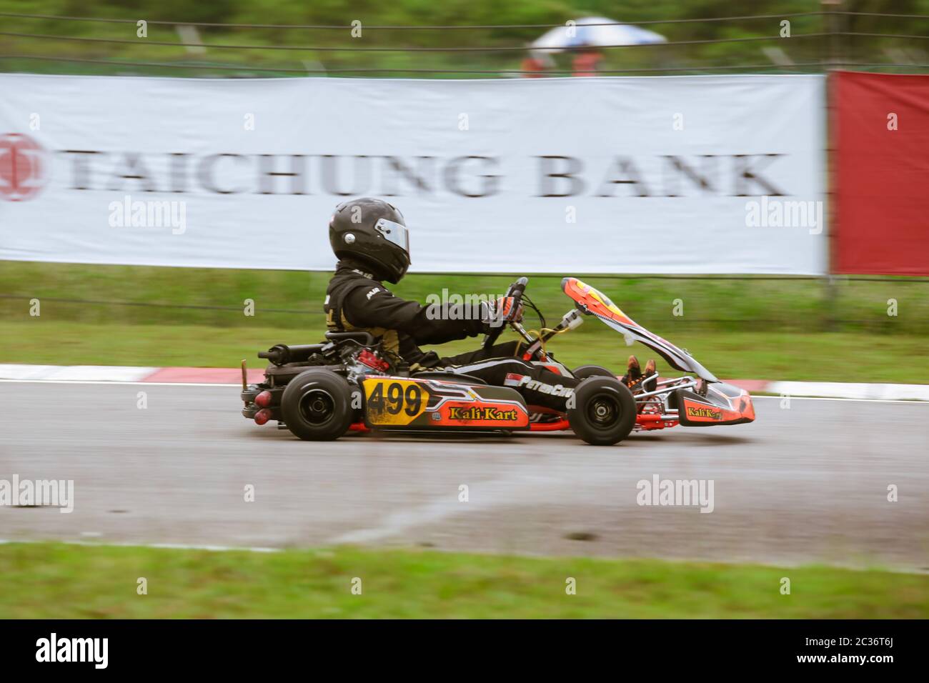 Kart racers speeding along a track corner Stock Photo - Alamy