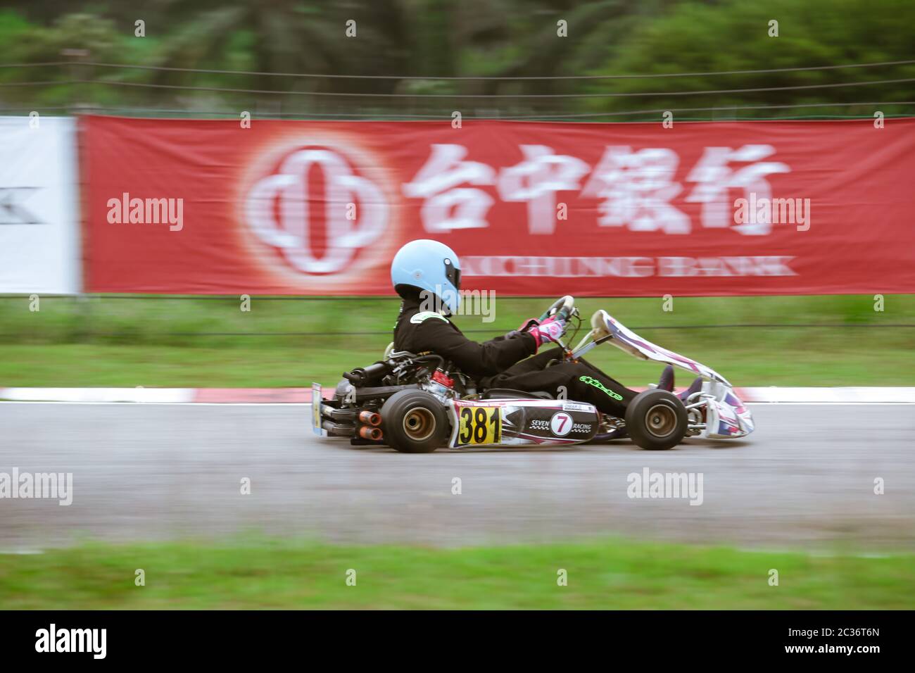 Kart racers speeding along a track corner Stock Photo - Alamy