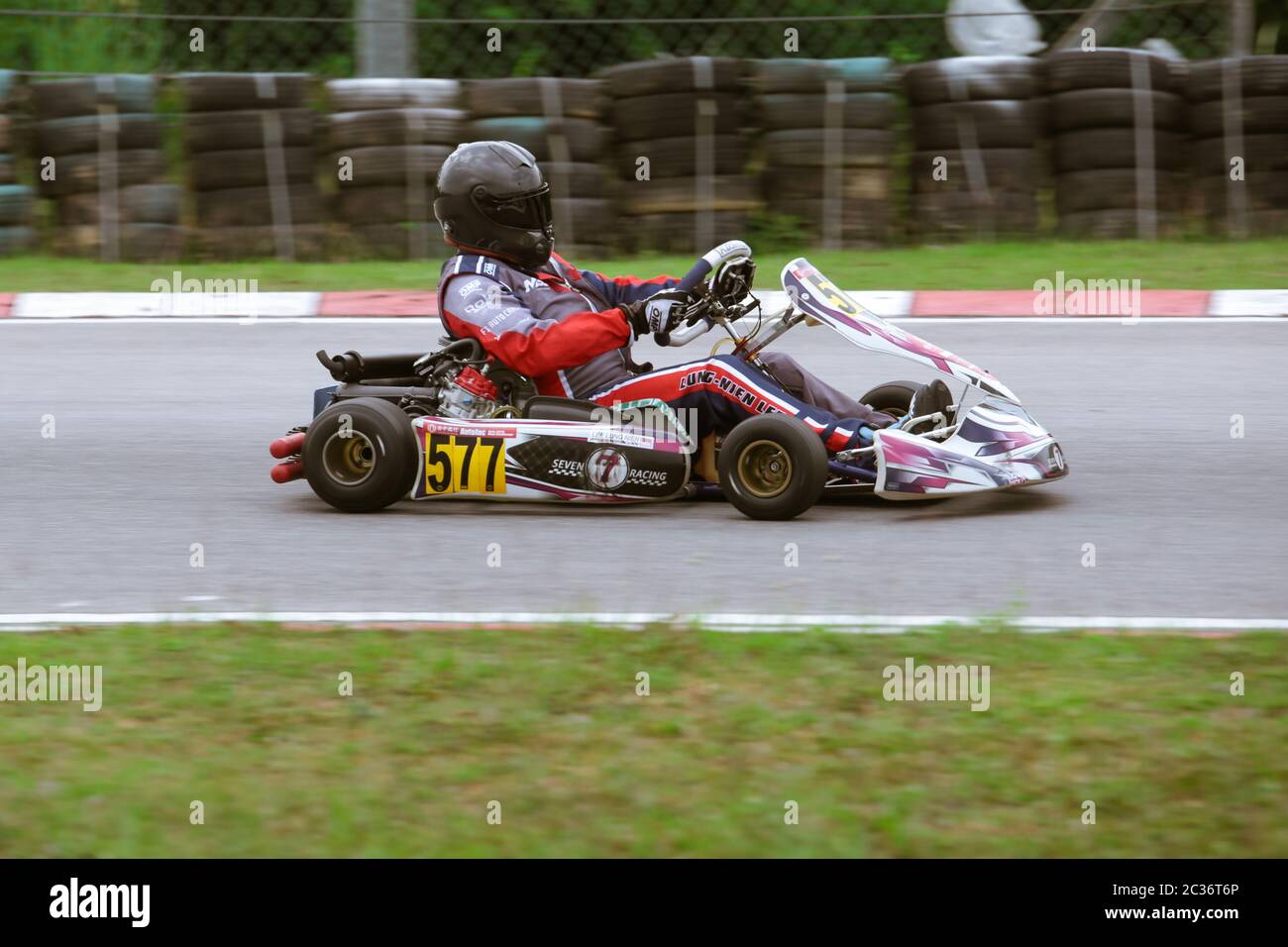 Kart racers speeding along a track corner Stock Photo - Alamy
