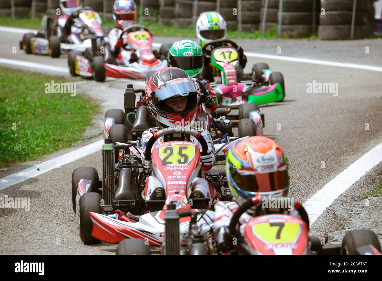 Kart racers zig-zaging into the pit stop zone after the race finish ...