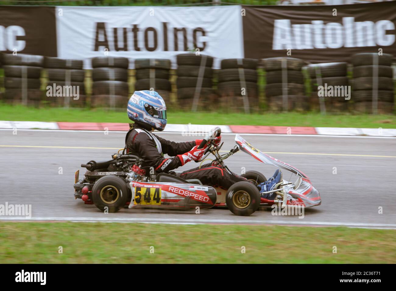 Kart racers speeding along a track corner Stock Photo - Alamy
