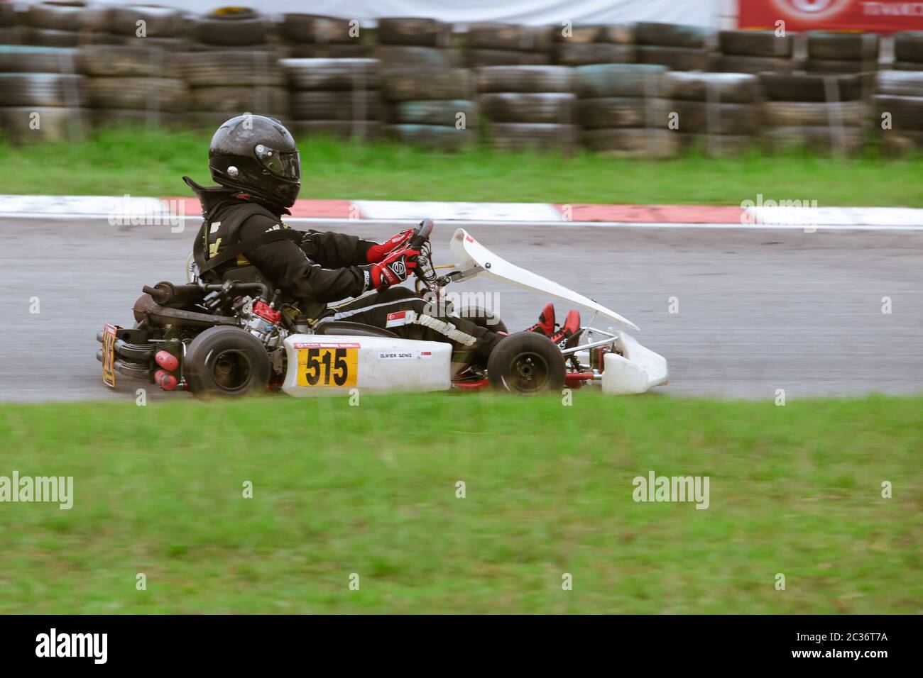 Kart racers speeding along a track corner Stock Photo - Alamy