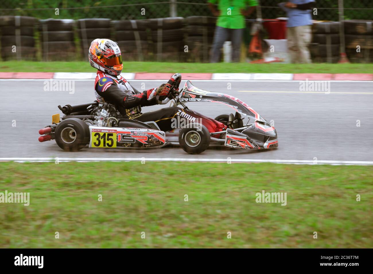 Kart racers speeding along a track corner Stock Photo - Alamy