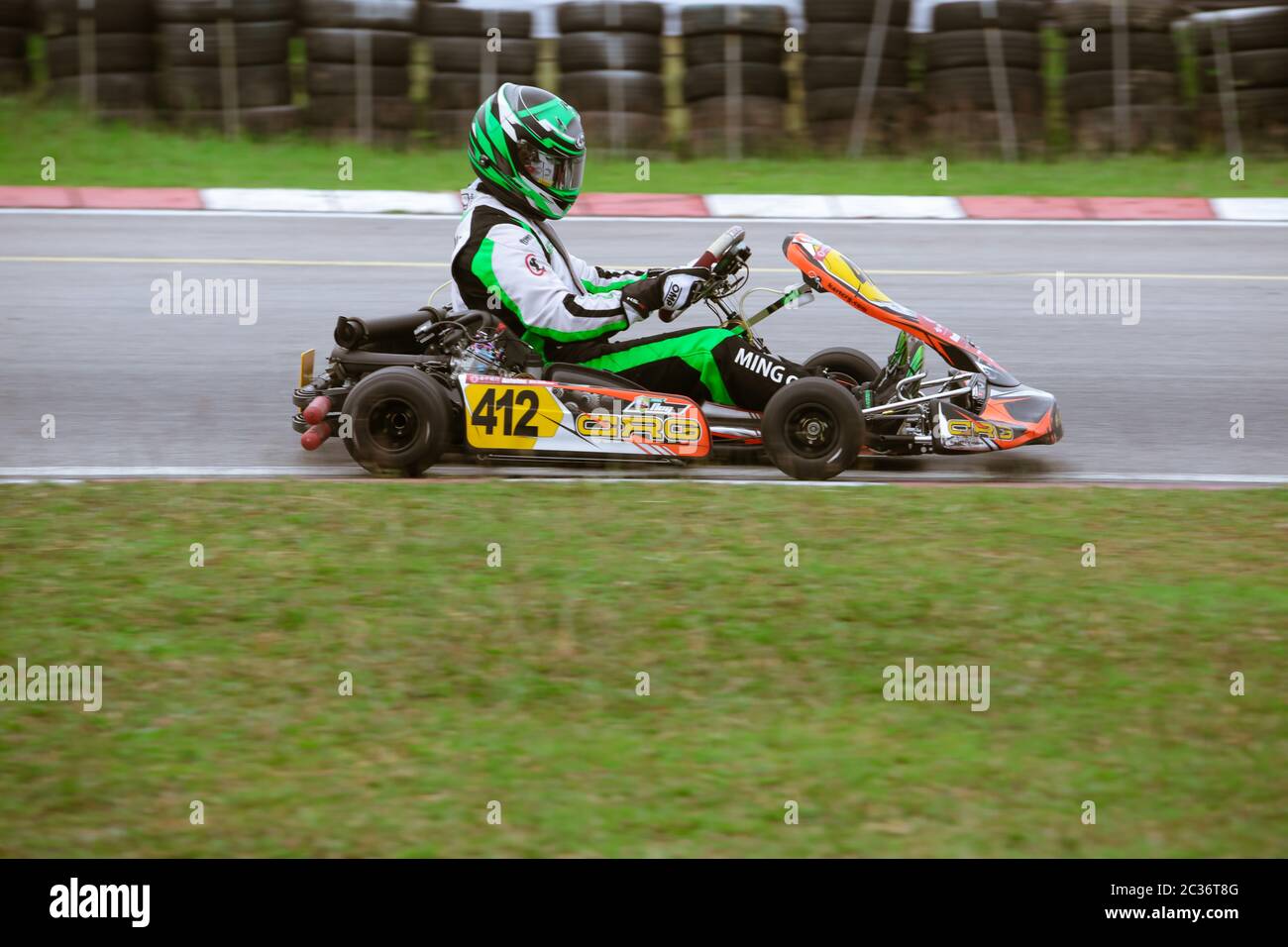 Kart racers speeding along a track corner Stock Photo - Alamy