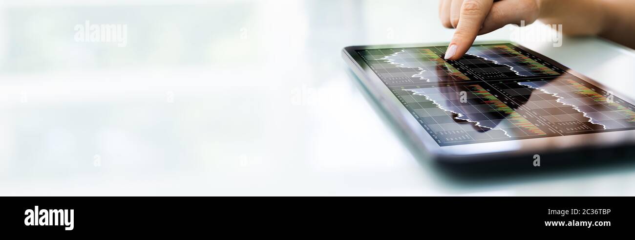 Stock Broker Looking At Chart Online Using Tablet Technology Stock ...