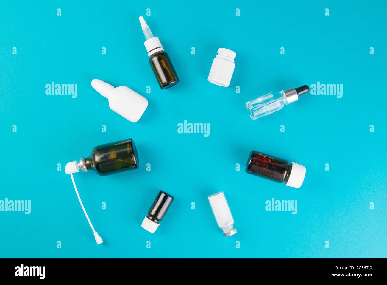 Different vials and sprays with medicines are laid out in the form of a ...