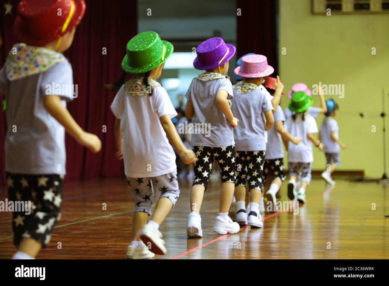 Kindergarten kids perform dance on stage during their year end ...
