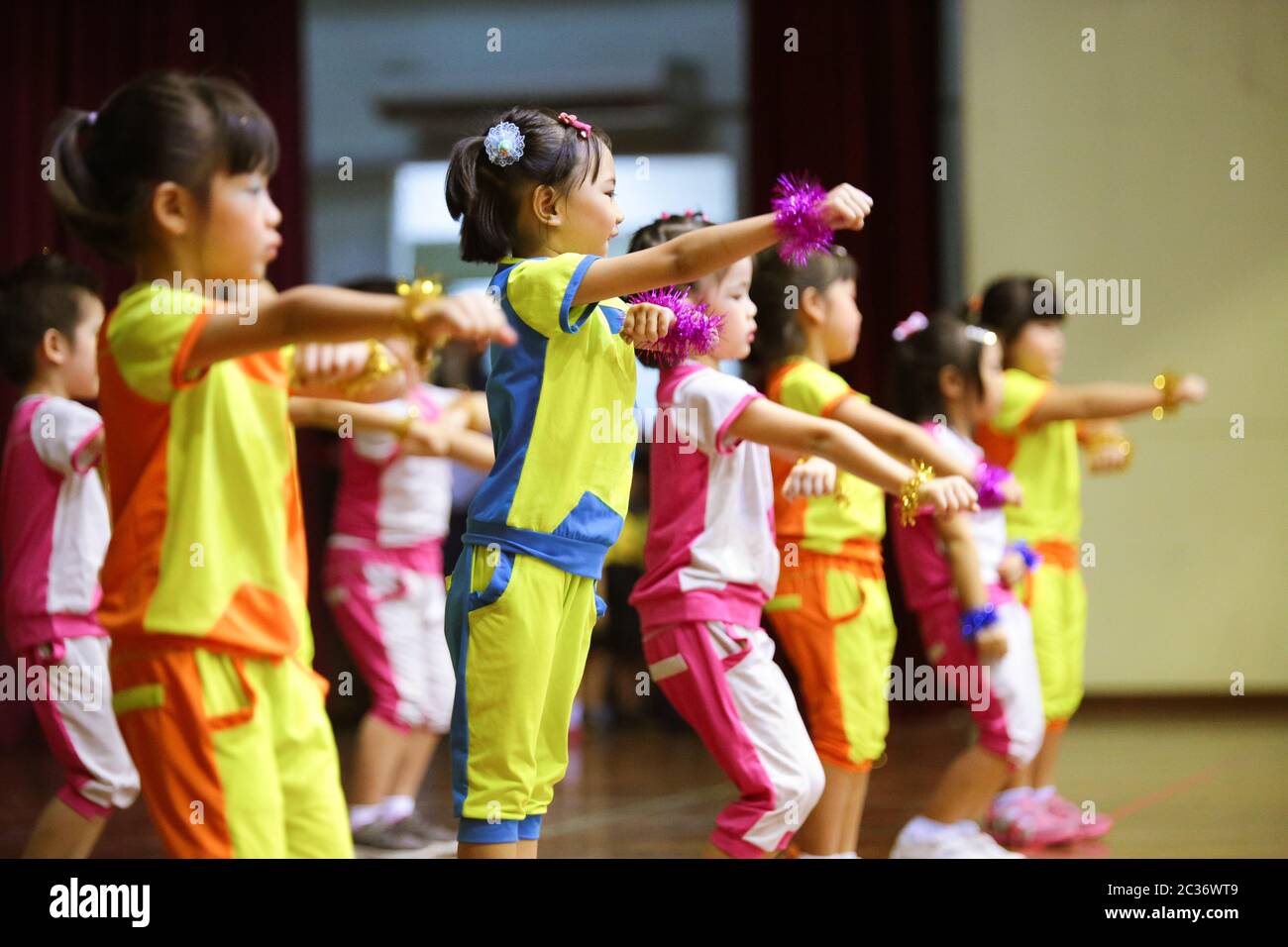 Kindergarten kids perform dance on stage during their year end ...
