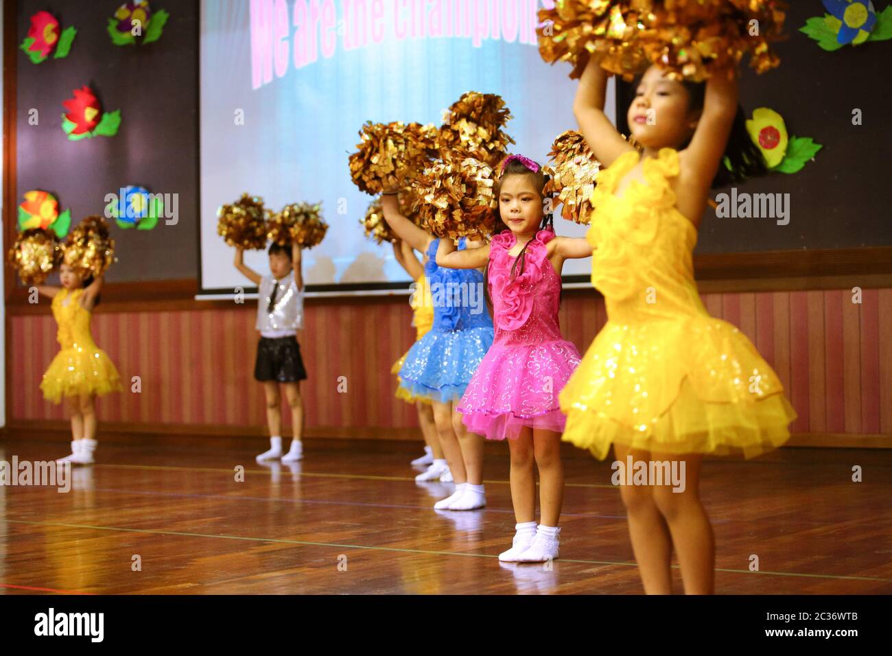 Kindergarten kids perform dance on stage during their year end ...