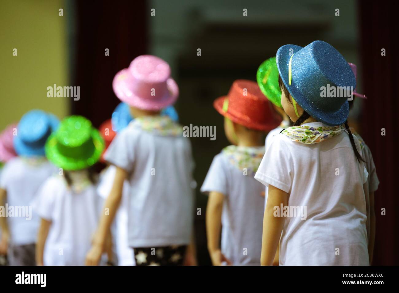 Kindergarten kids perform dance on stage during their year end ...