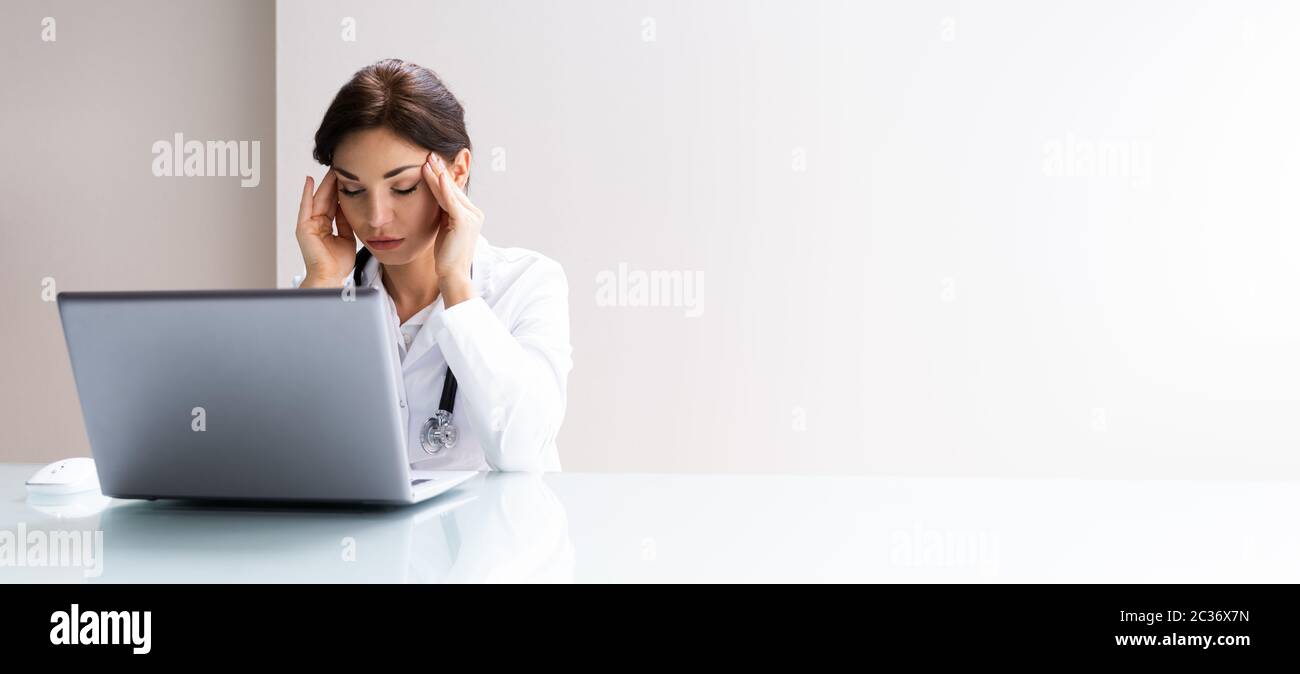 Sad Stressed Doctor Having Pain Using Computer Stock Photo - Alamy