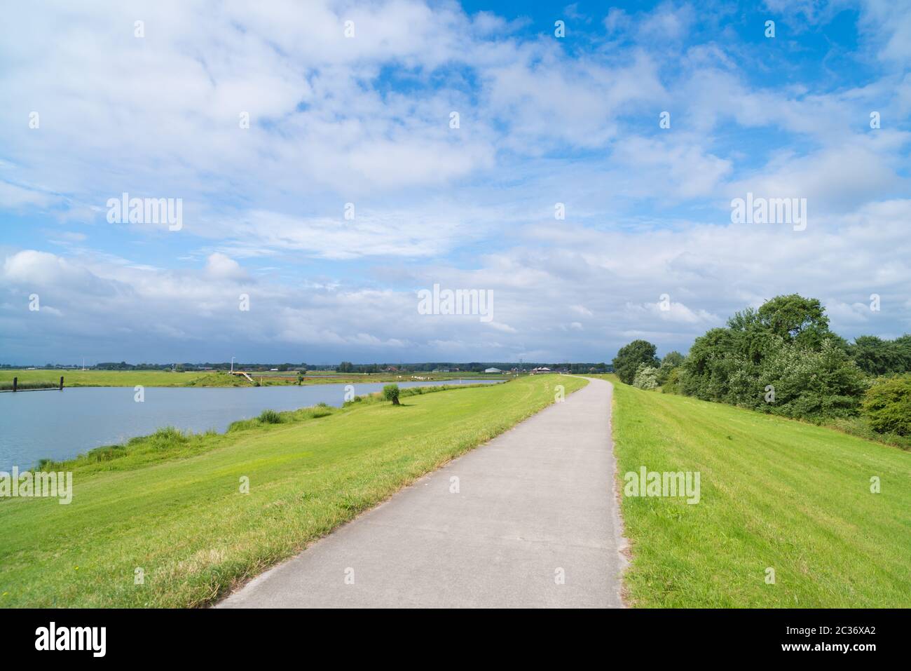 empty bicycle path over a dike along the Ijssel river in the ...