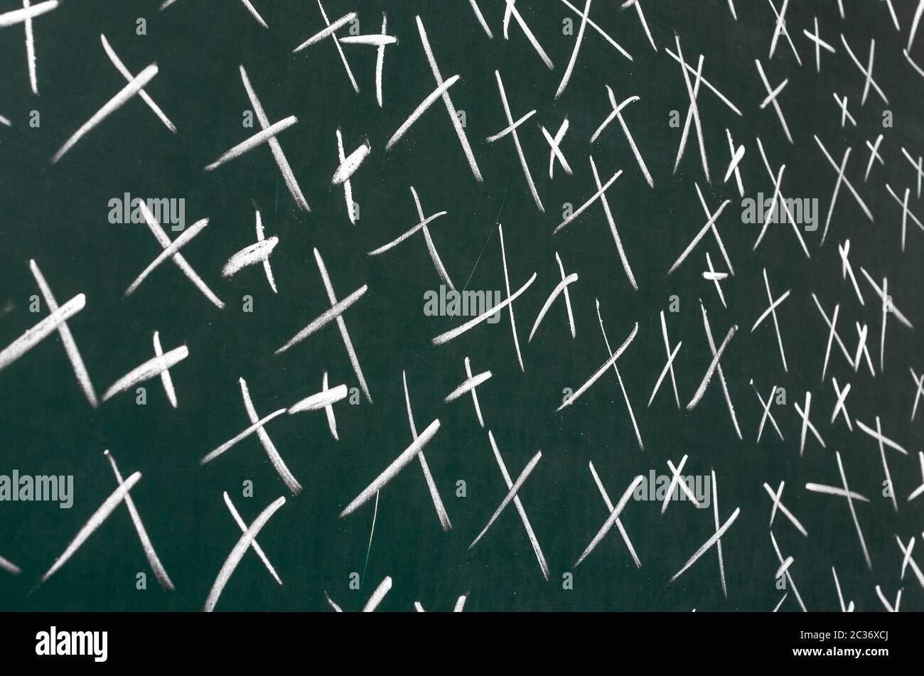 On blackboard with chalk drawn a lot of crosses Stock Photo - Alamy