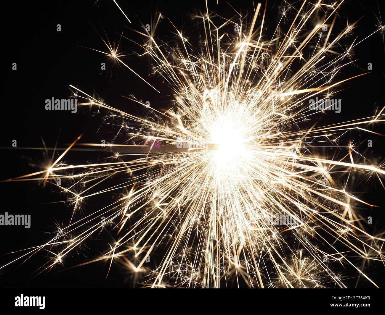 Bright sparkler on a dark background, New Years or birthday concept ...