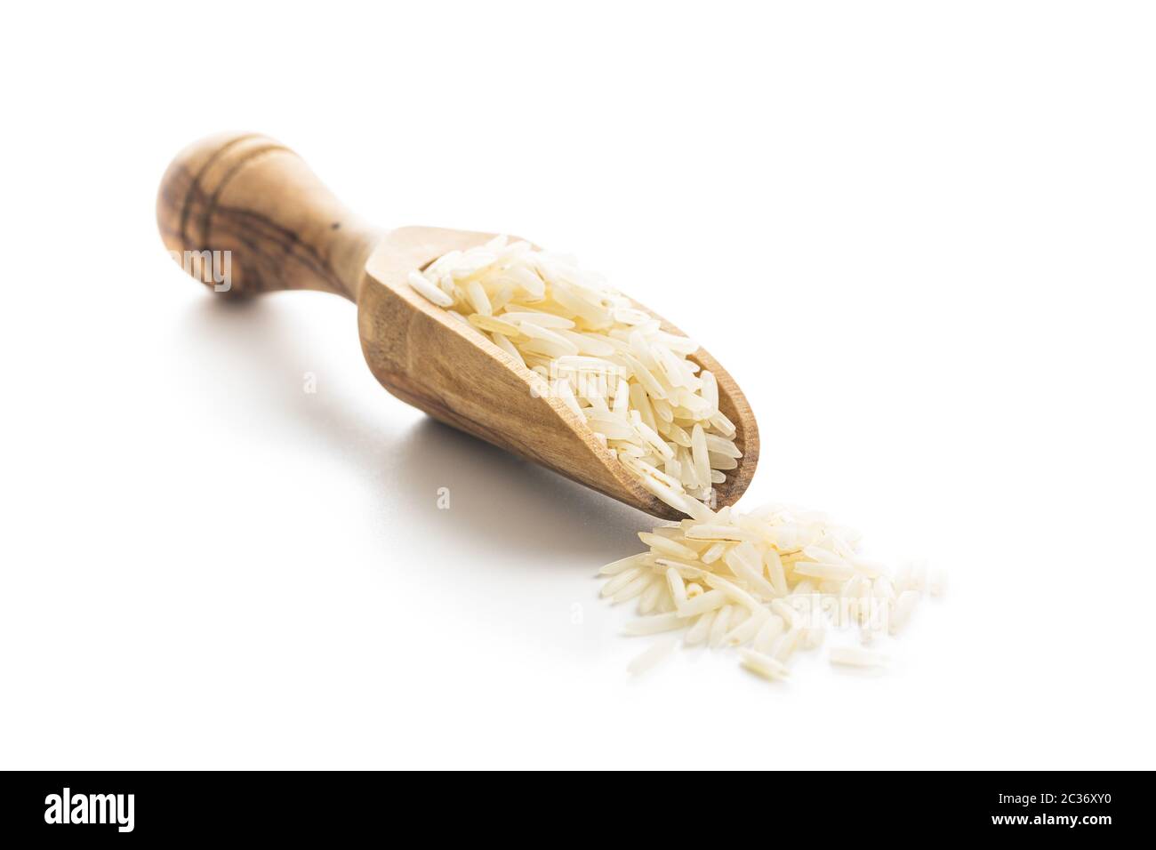 Uncooked indian long rice in wooden scoop isolated on white background ...